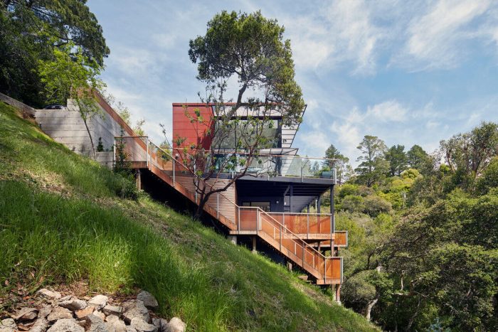 The Hillside House Wrapped in Rusted Steel with a Bright Yellow ...